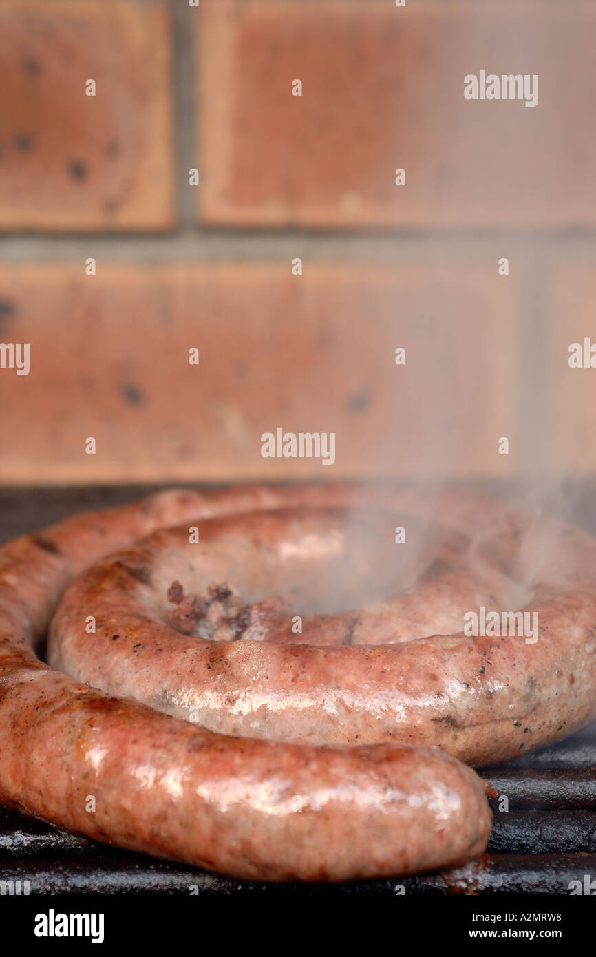 Traditional South African 'boerewors' sausage cooking on a barbecue ...