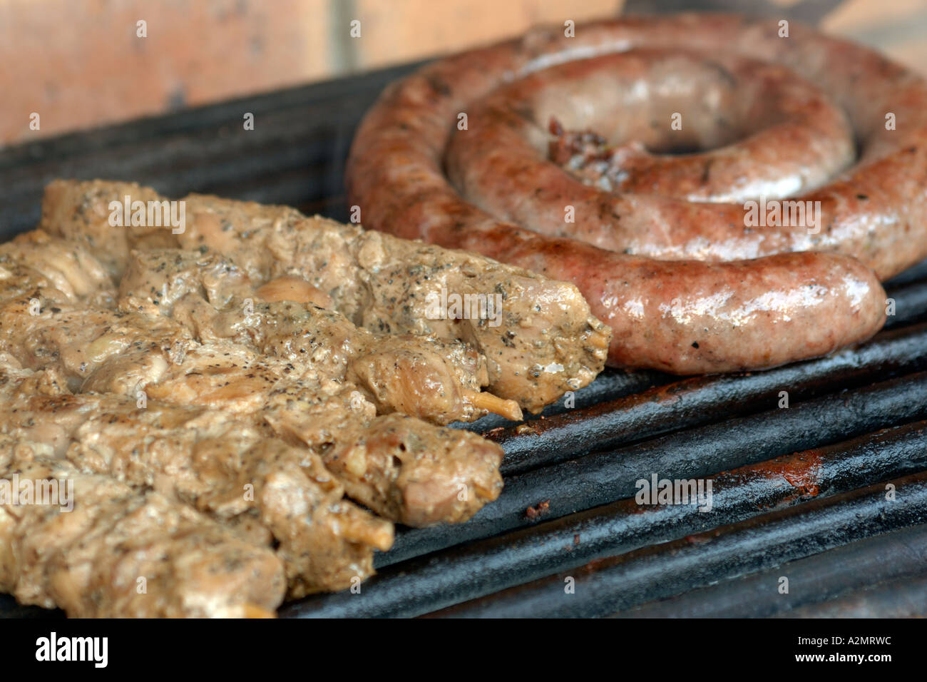 South African boerewors sausage and kebabs cooking on a barbeque Stock ...