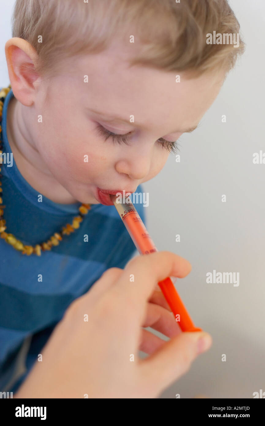 baby getting medicine with syringe into mouth Stock Photo - Alamy