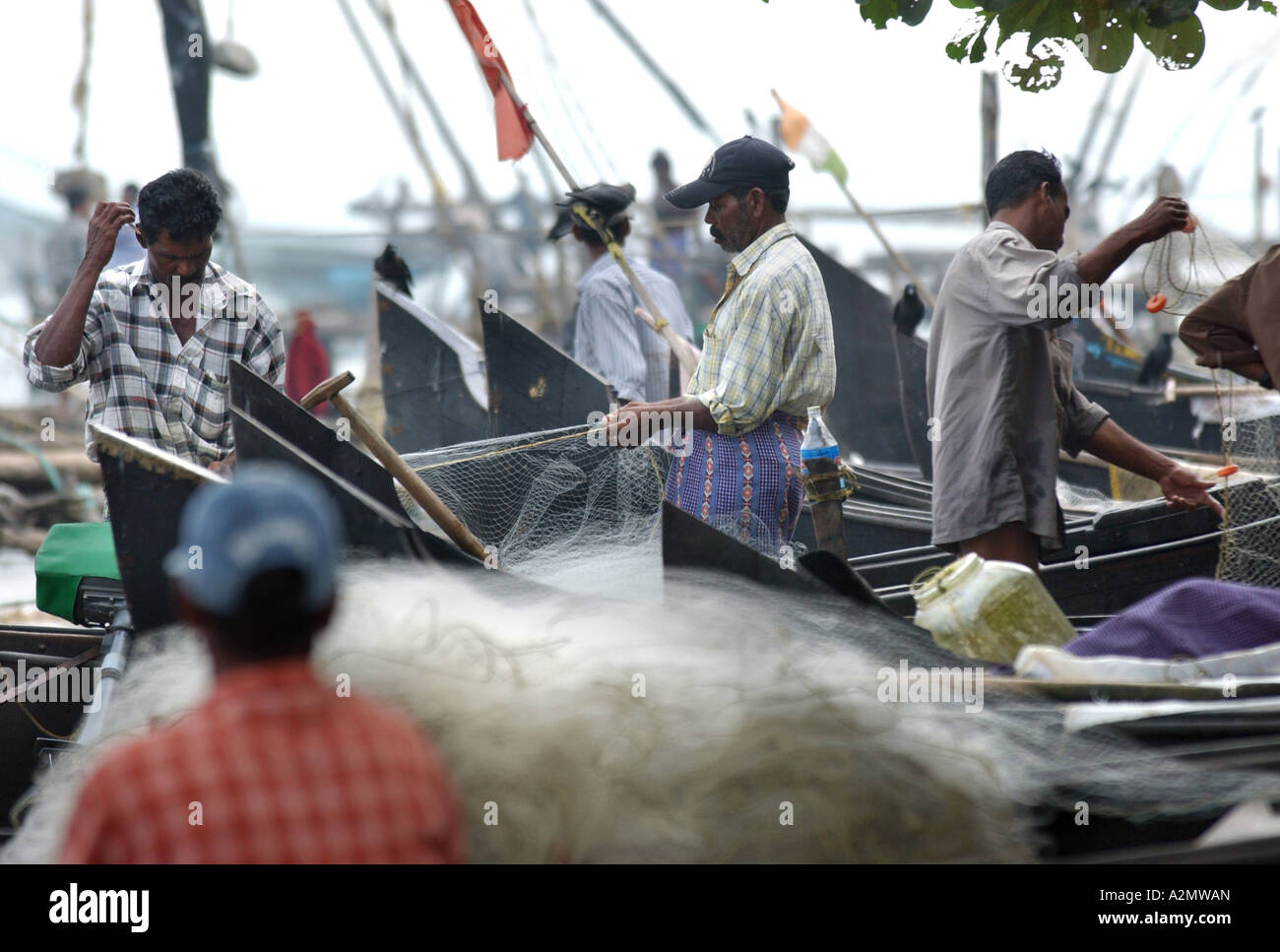 Fishermen work on their fishing nets Cochin Kerala India Stock Photo ...