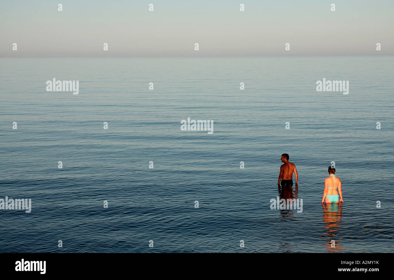 couple in sea enjoying the peace of a tranquil morning Stock Photo - Alamy