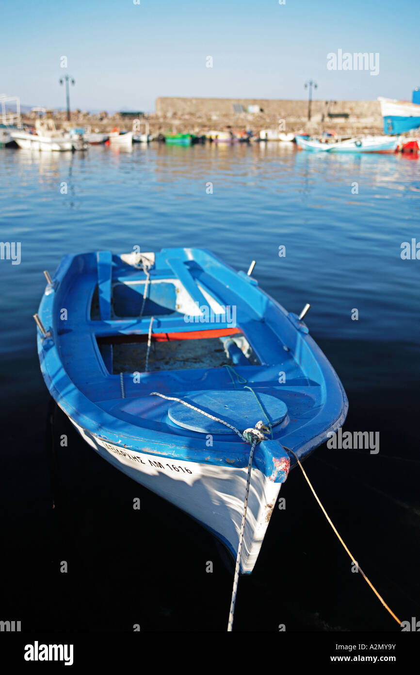 single fishing boat in peaceful harbor Stock Photo - Alamy