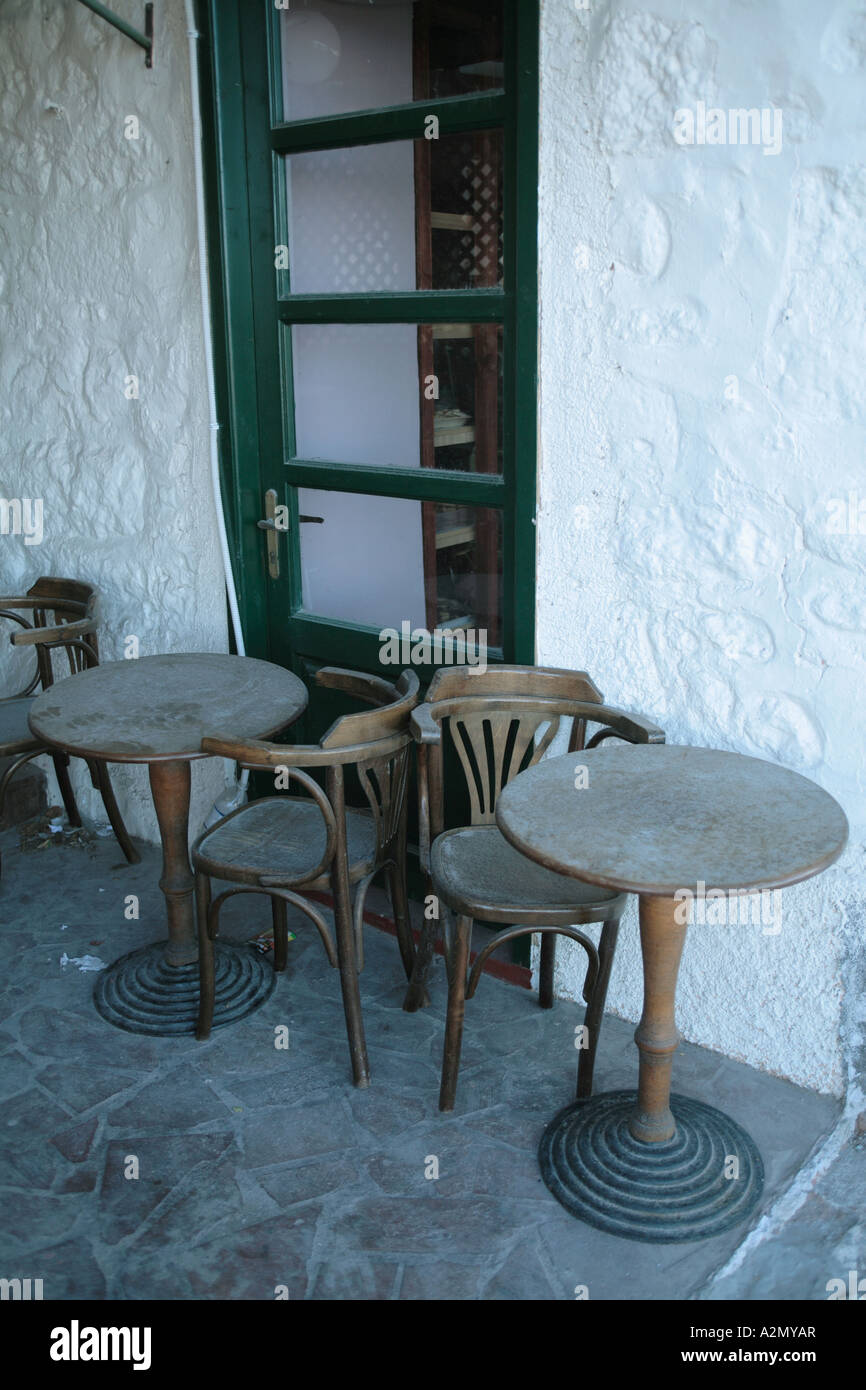 dust covered disused taverna tables and chairs Stock Photo - Alamy