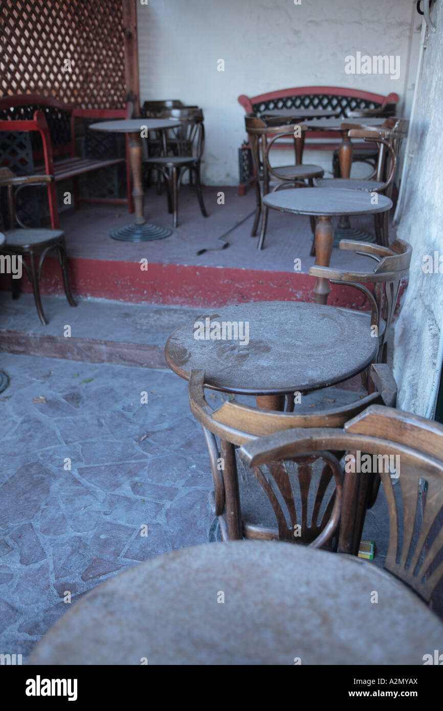 dust covered disused taverna tables and chairs Stock Photo - Alamy