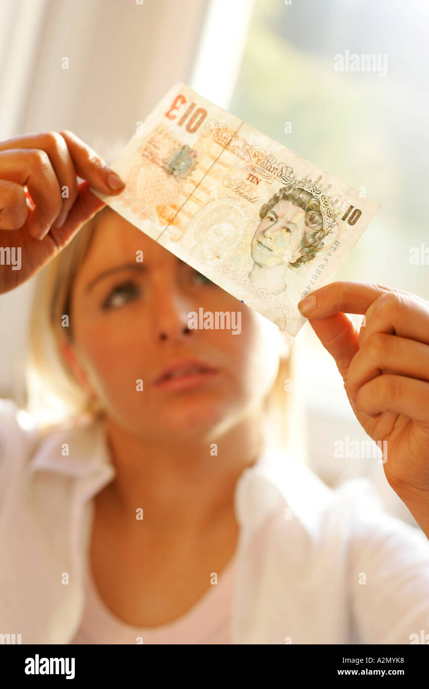 woman examining a ten pound note Stock Photo - Alamy