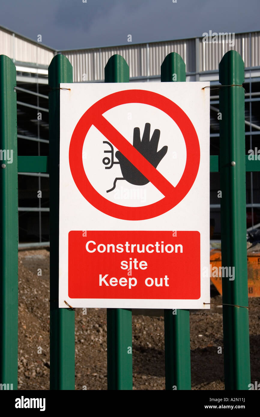 a colourful red and white warning sign which says Construction site ...