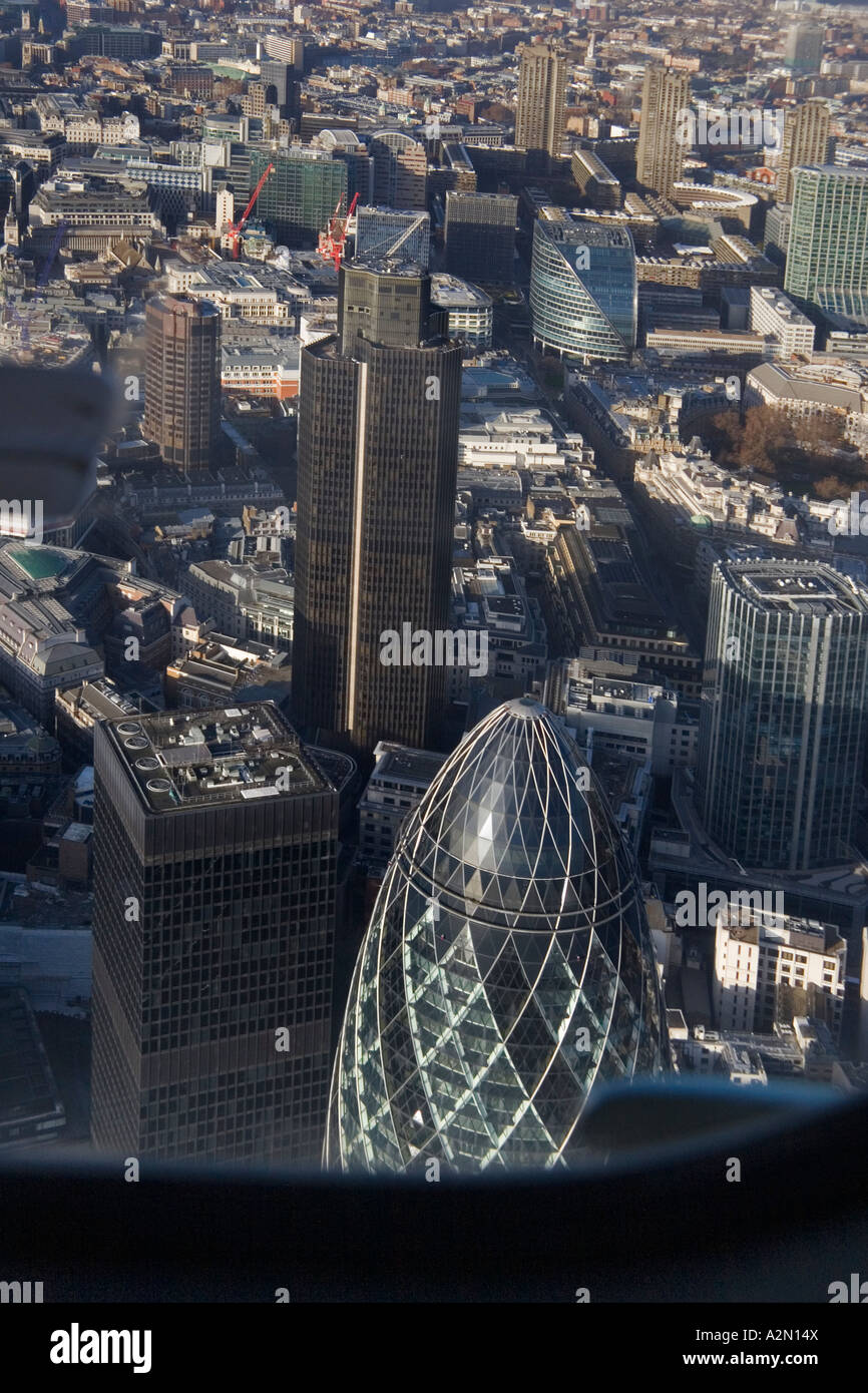 a close up aerial view from the inside of a helicopter of the Gherkin ...