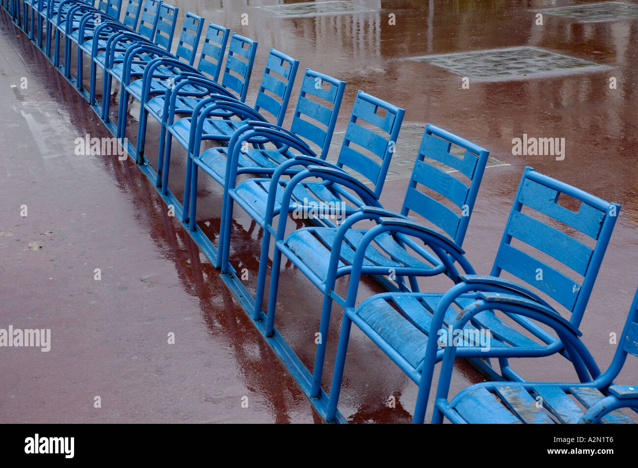 line of blue chairs in the rain Stock Photo - Alamy