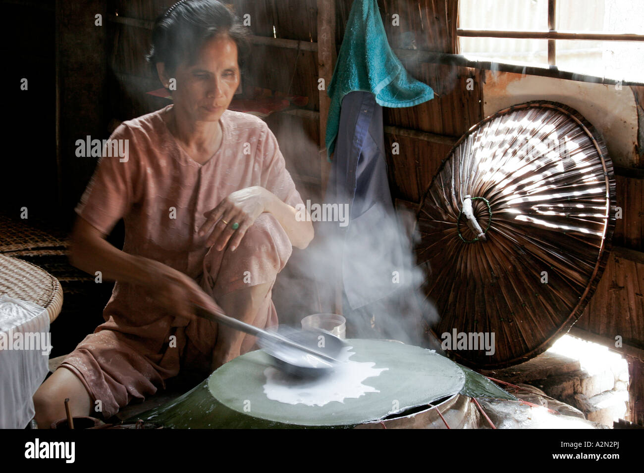 A Vietnamese lady is making rice paper the traditional way Stock Photo ...