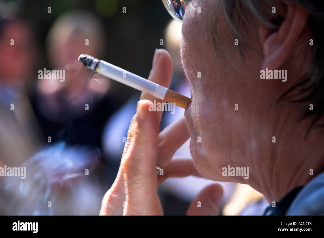 Senior woman is smoking a cigarette hi-res stock photography and images ...