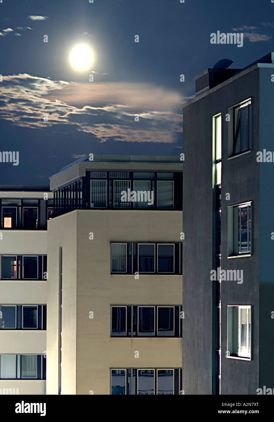 Full moon over city Stock Photo - Alamy