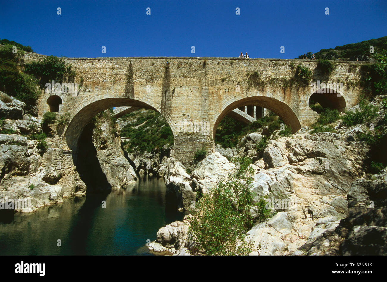 Arch bridge across river, Pont Du Diable, Cevennes, Herault River ...