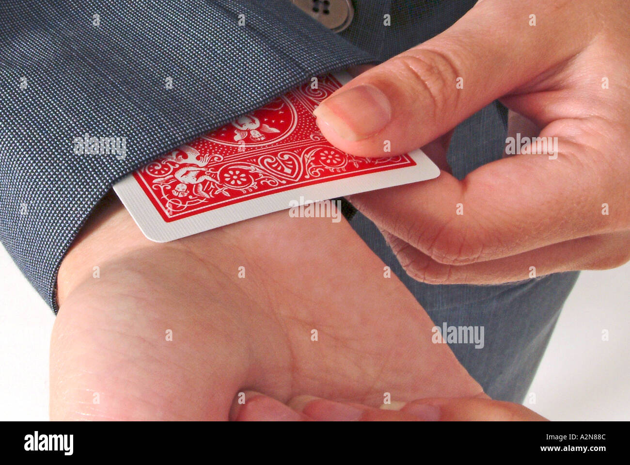 Womans hands pulling hidden card out from sleeve Stock Photo - Alamy