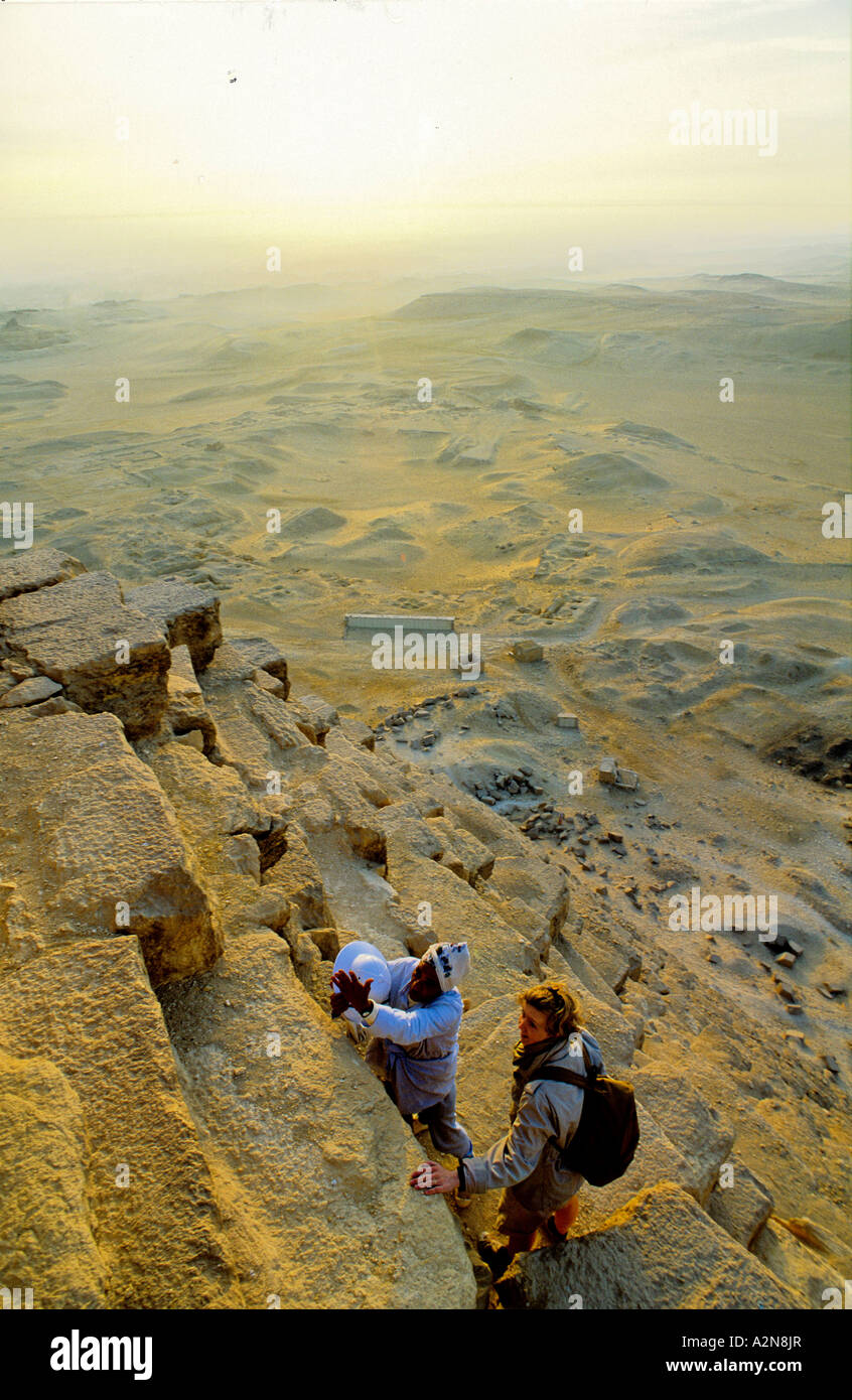 Two people standing on pyramid, Giza Pyramids, Giza, Cairo, Egypt Stock ...