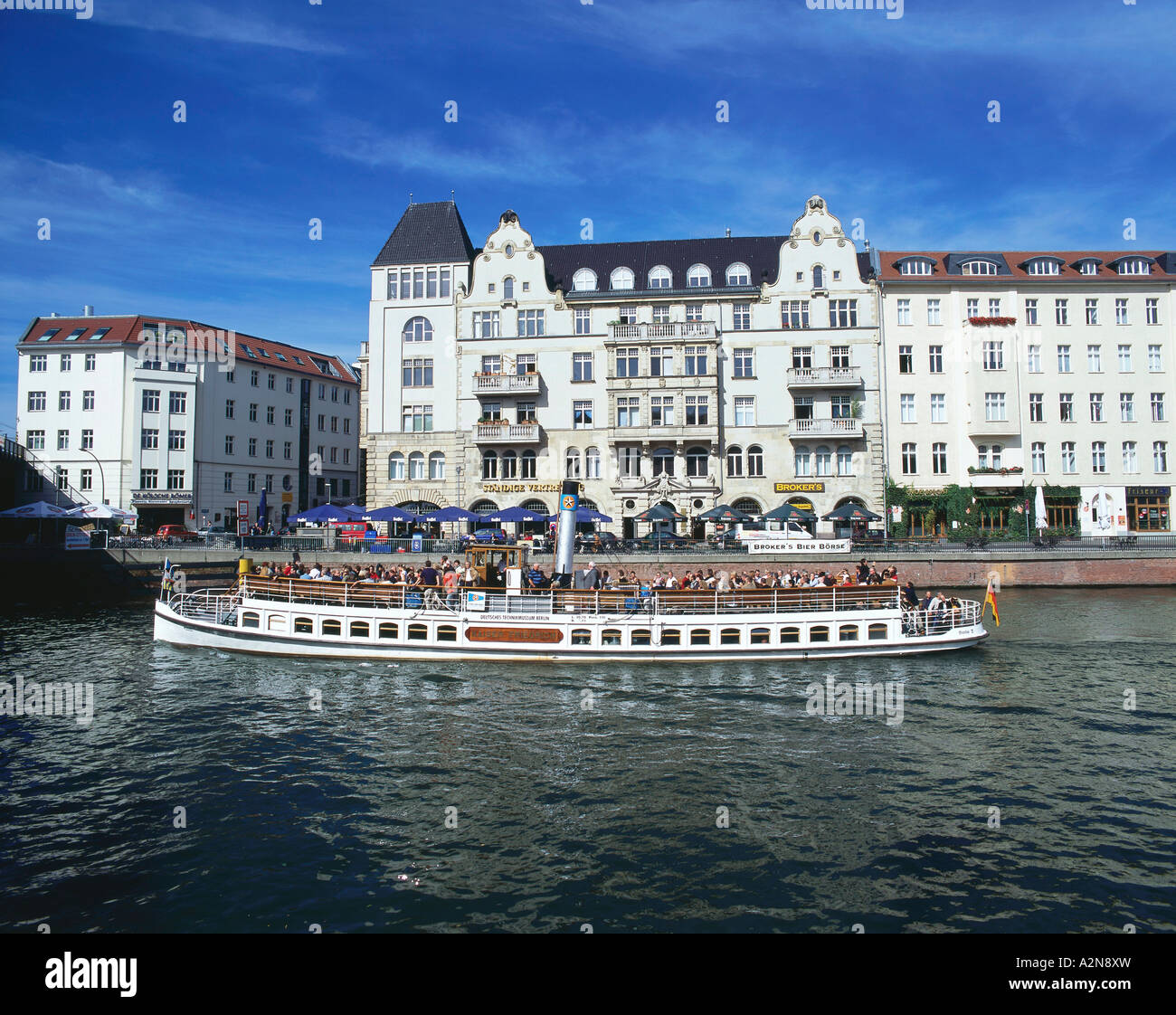Tourists traveling on tourboat in river, River Spree, Nicolaiviertel ...