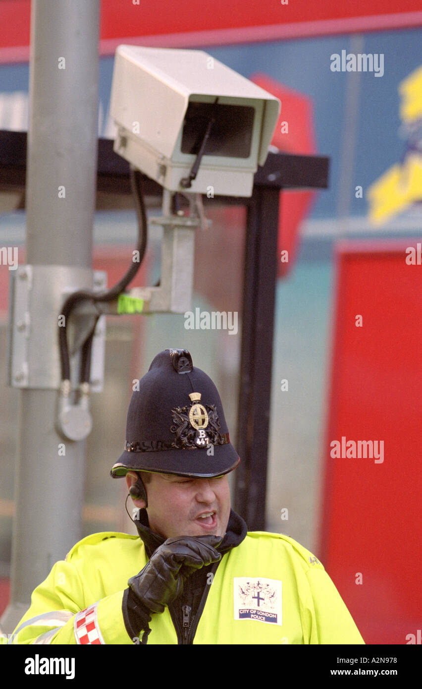 A policeman standing under a CCTV camera in London, England Stock Photo ...
