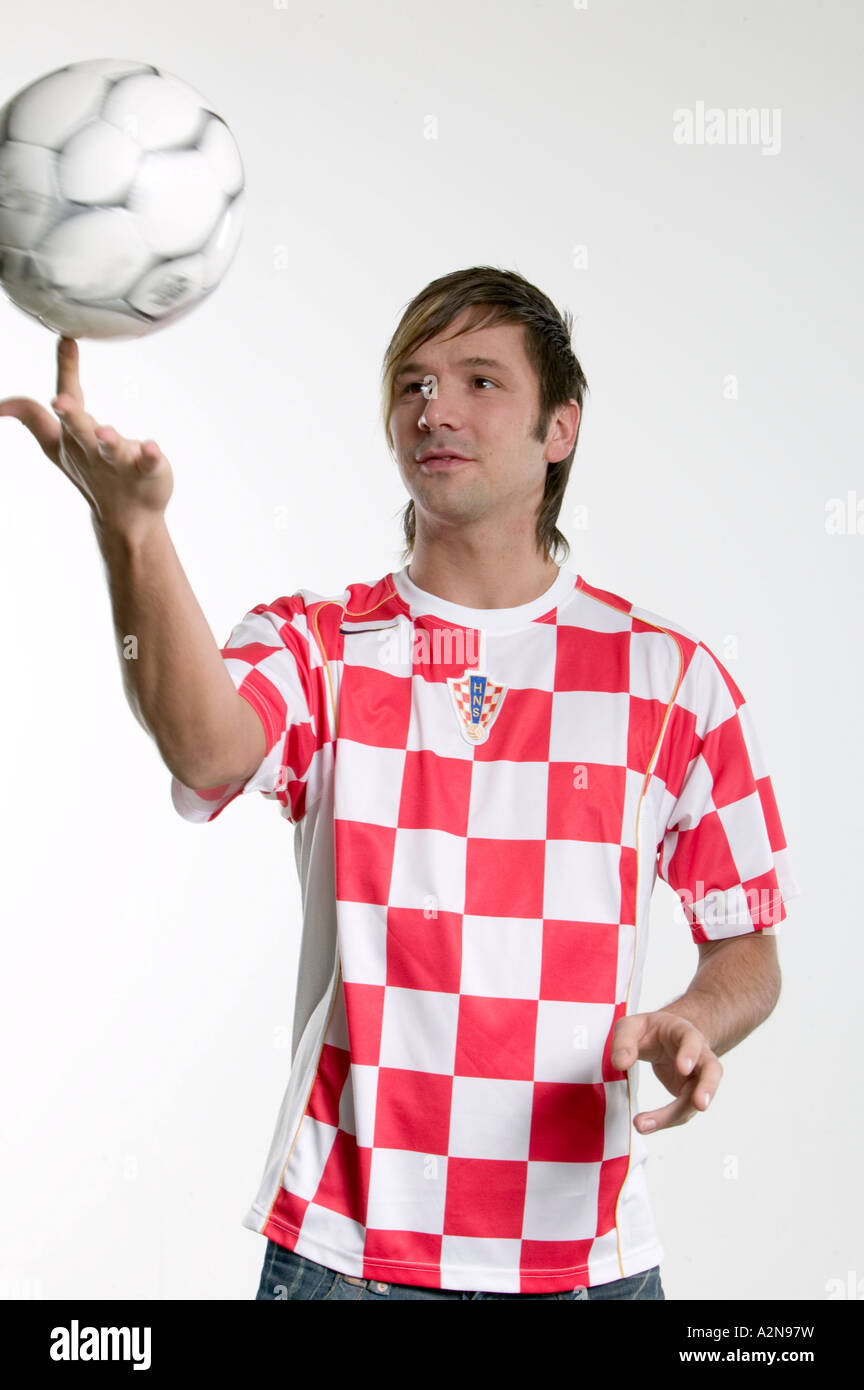 Young man balancing soccer ball on his finger Stock Photo - Alamy