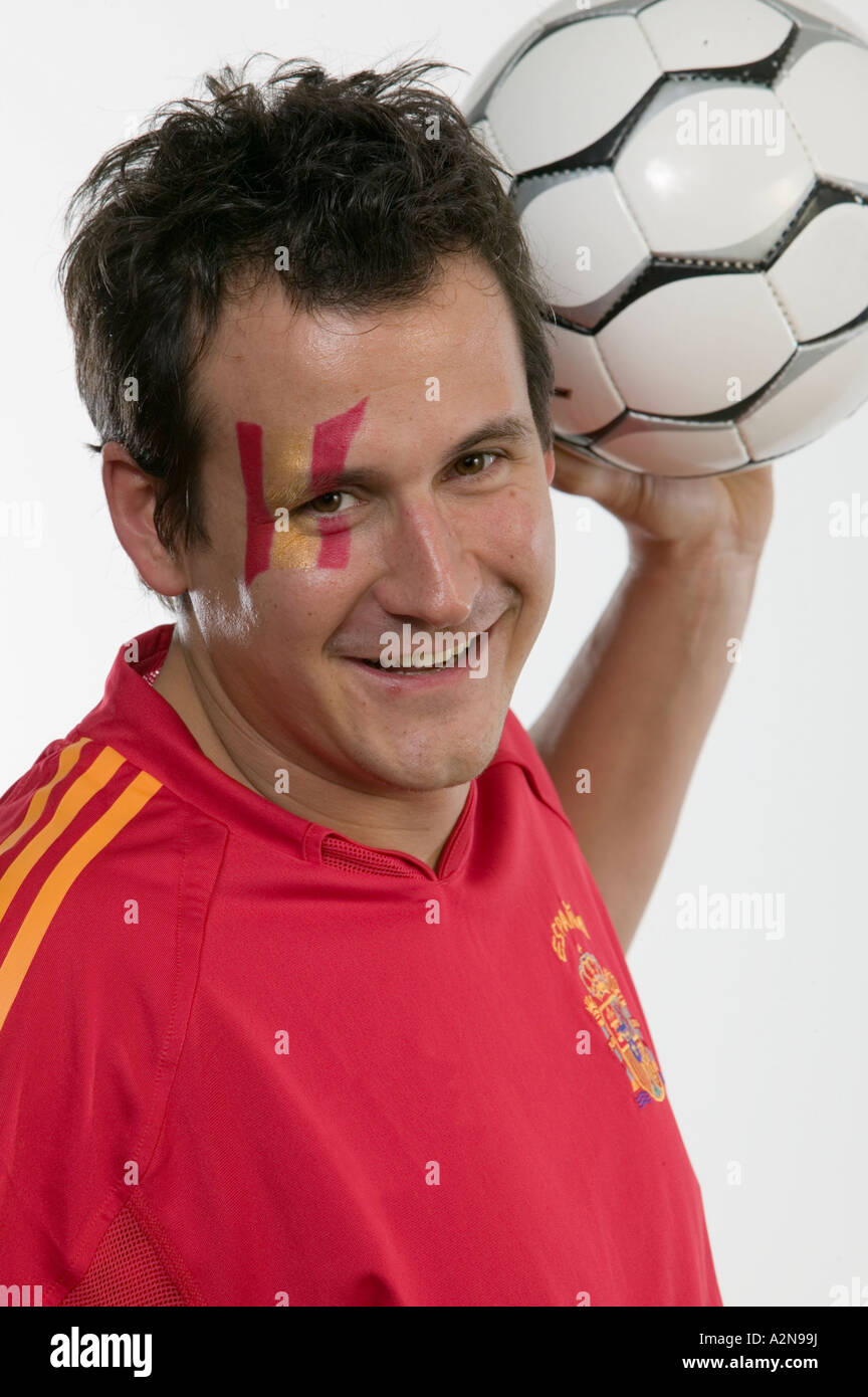 Portrait of male soccer fan holding soccer ball and smiling Stock Photo ...