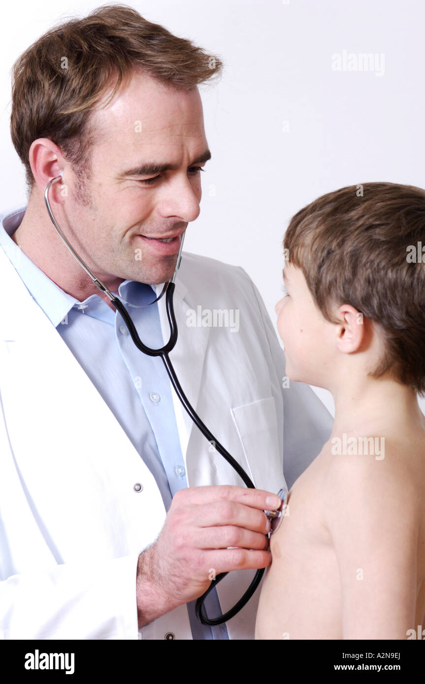 Male doctor examining boy with stethoscope Stock Photo - Alamy