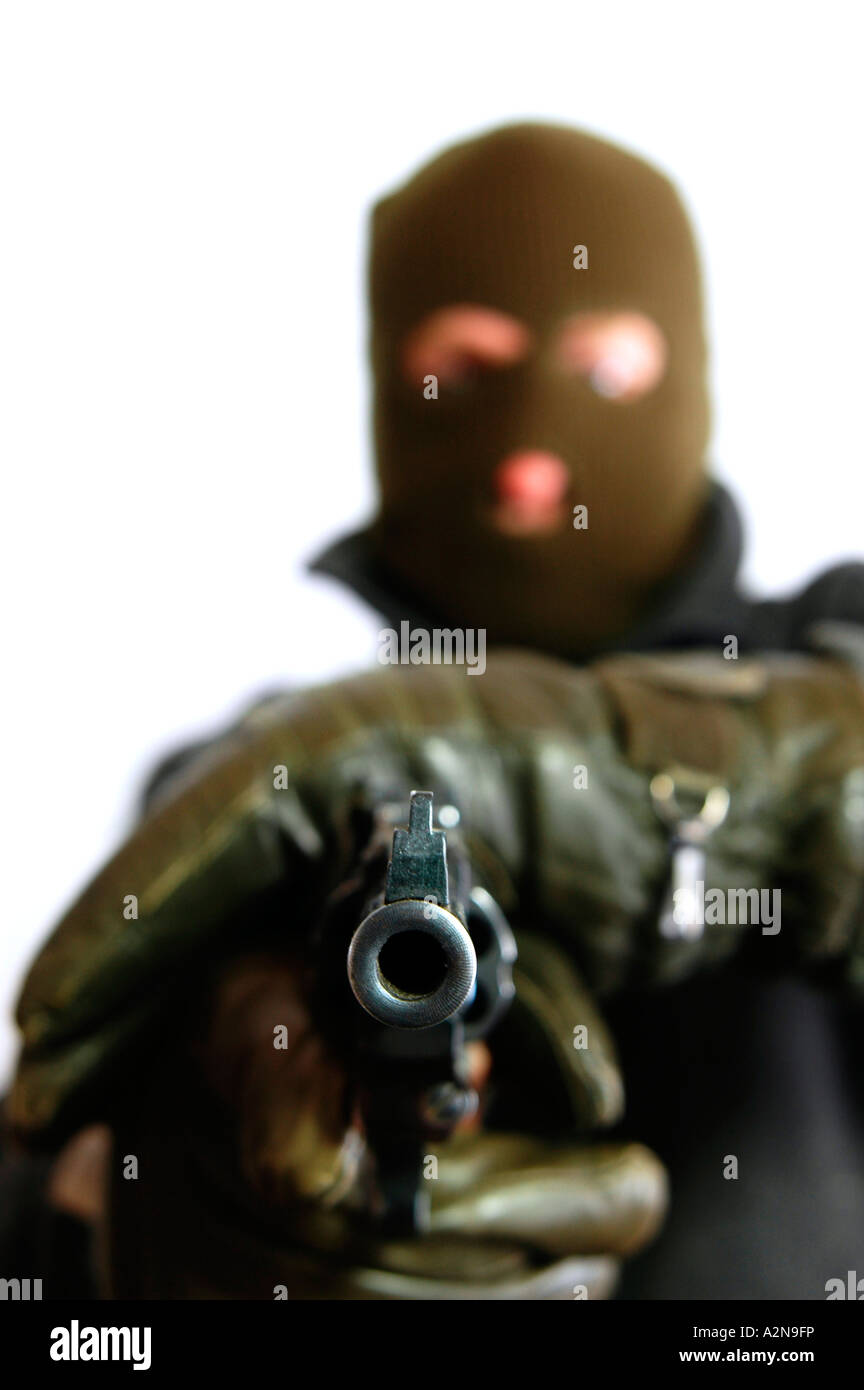 Masked man holding gun Stock Photo - Alamy