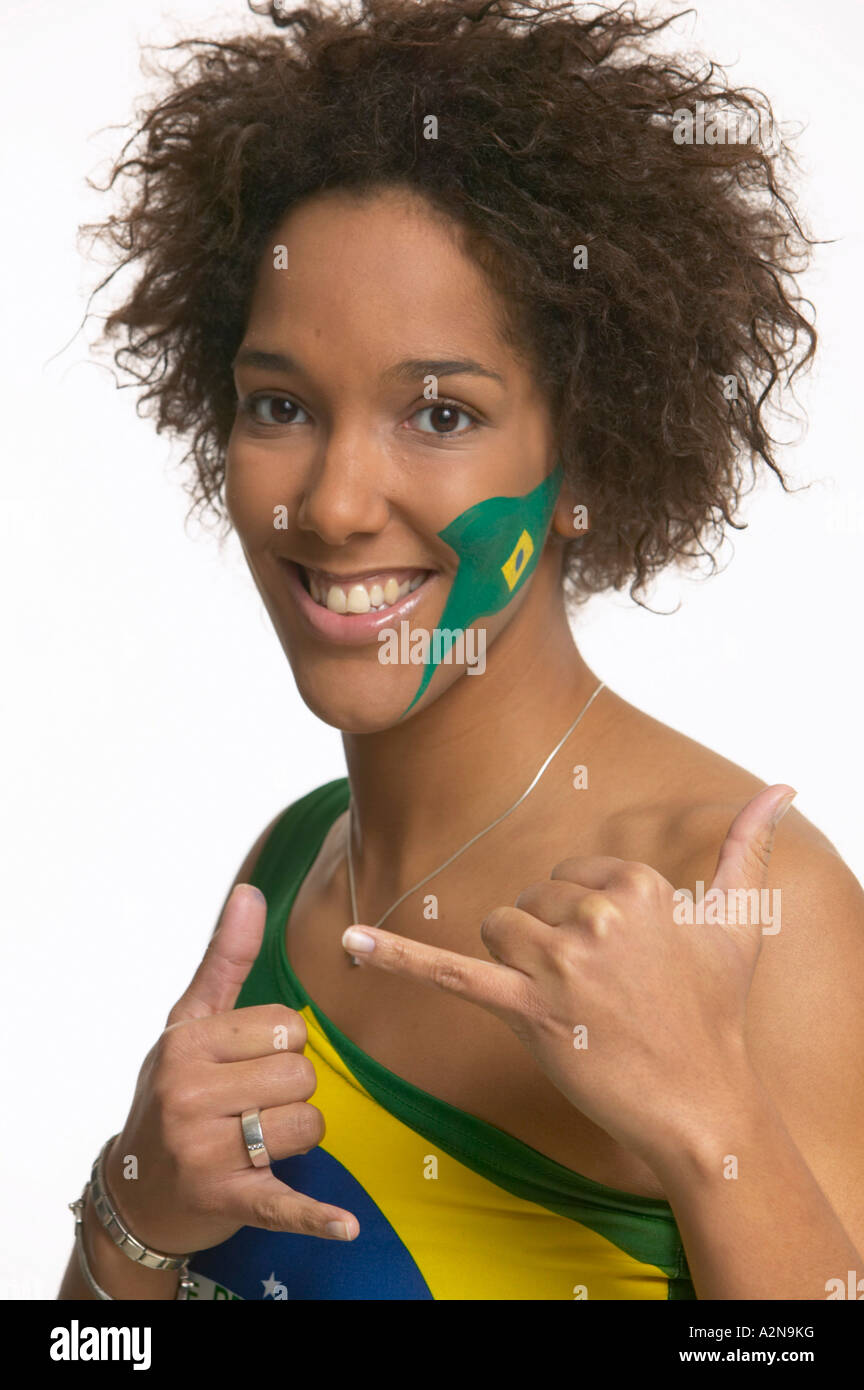 Portrait of young woman with Brazilian flag painted on her face Stock ...
