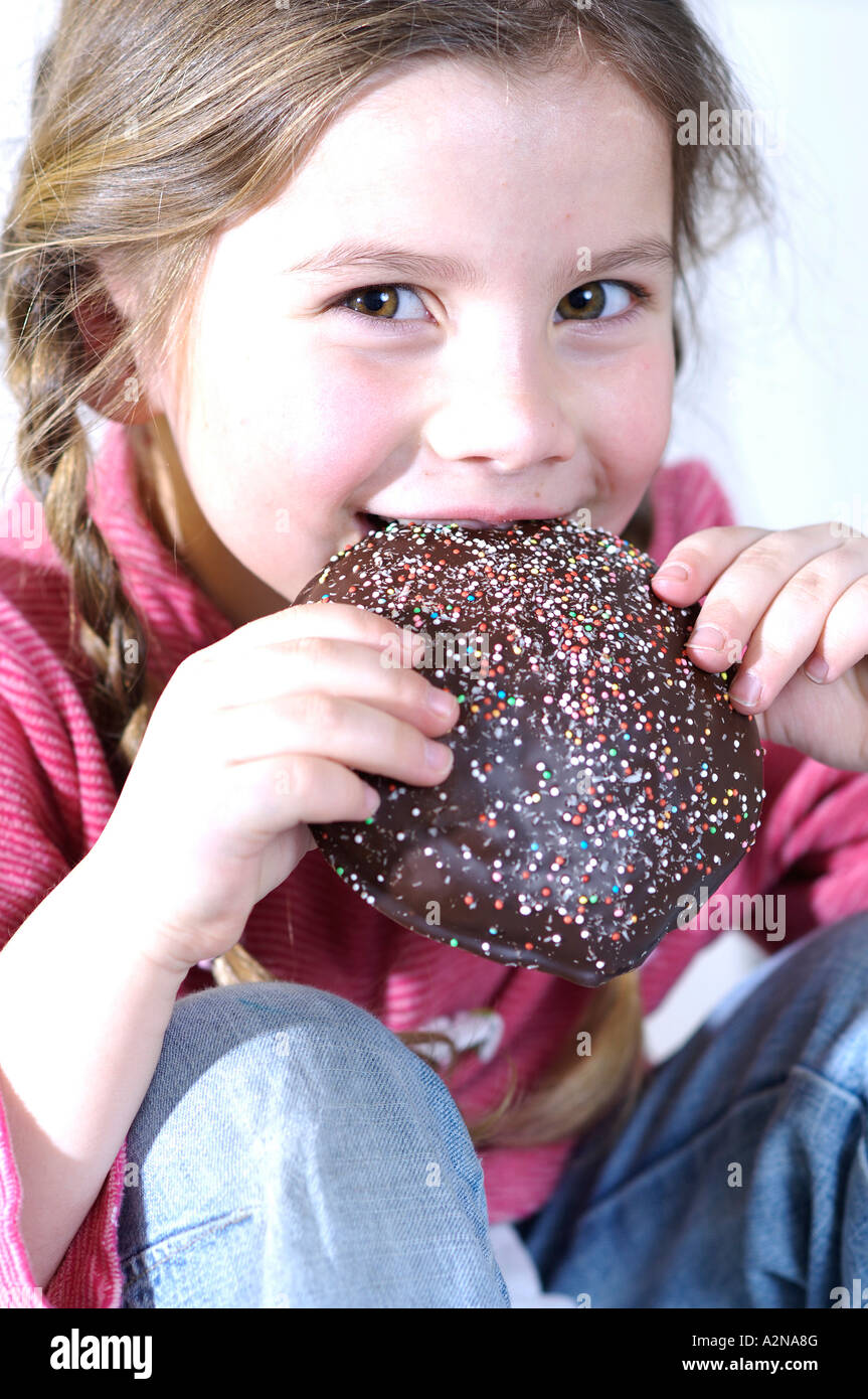 Portrait of girl eating gingerbread Stock Photo - Alamy