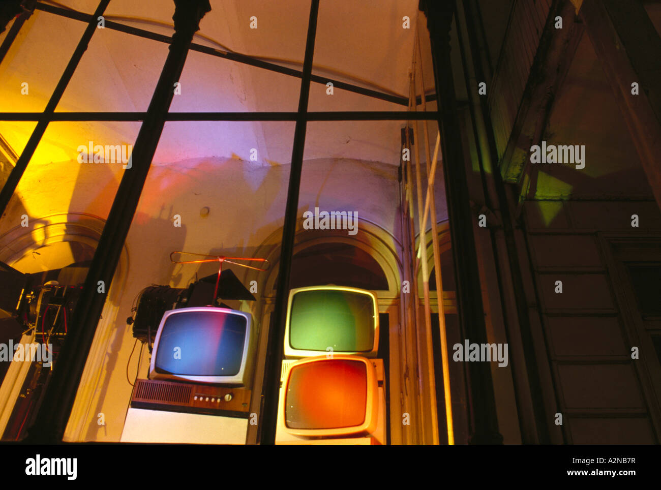 Television sets inside lit up room Stock Photo - Alamy