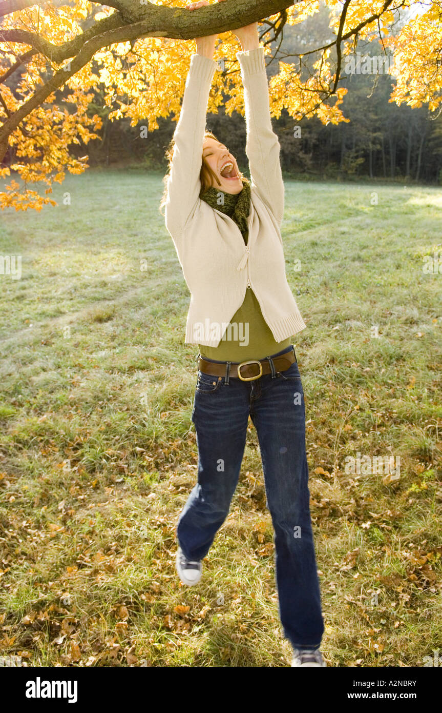 Girl Hanging From Tree Branch High Resolution Stock Photography and ...