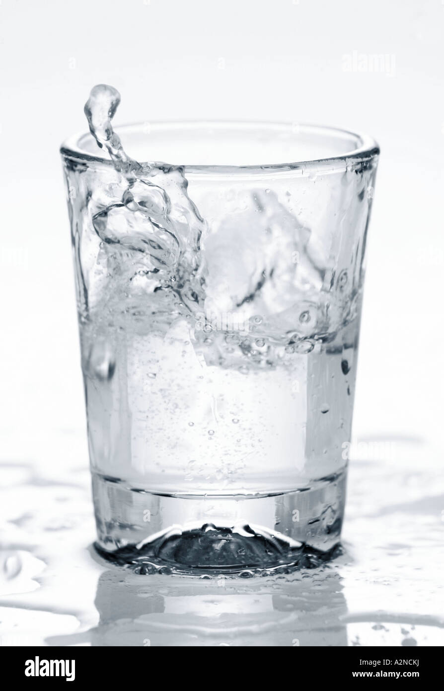 Close-up of water splashing into glass Stock Photo - Alamy