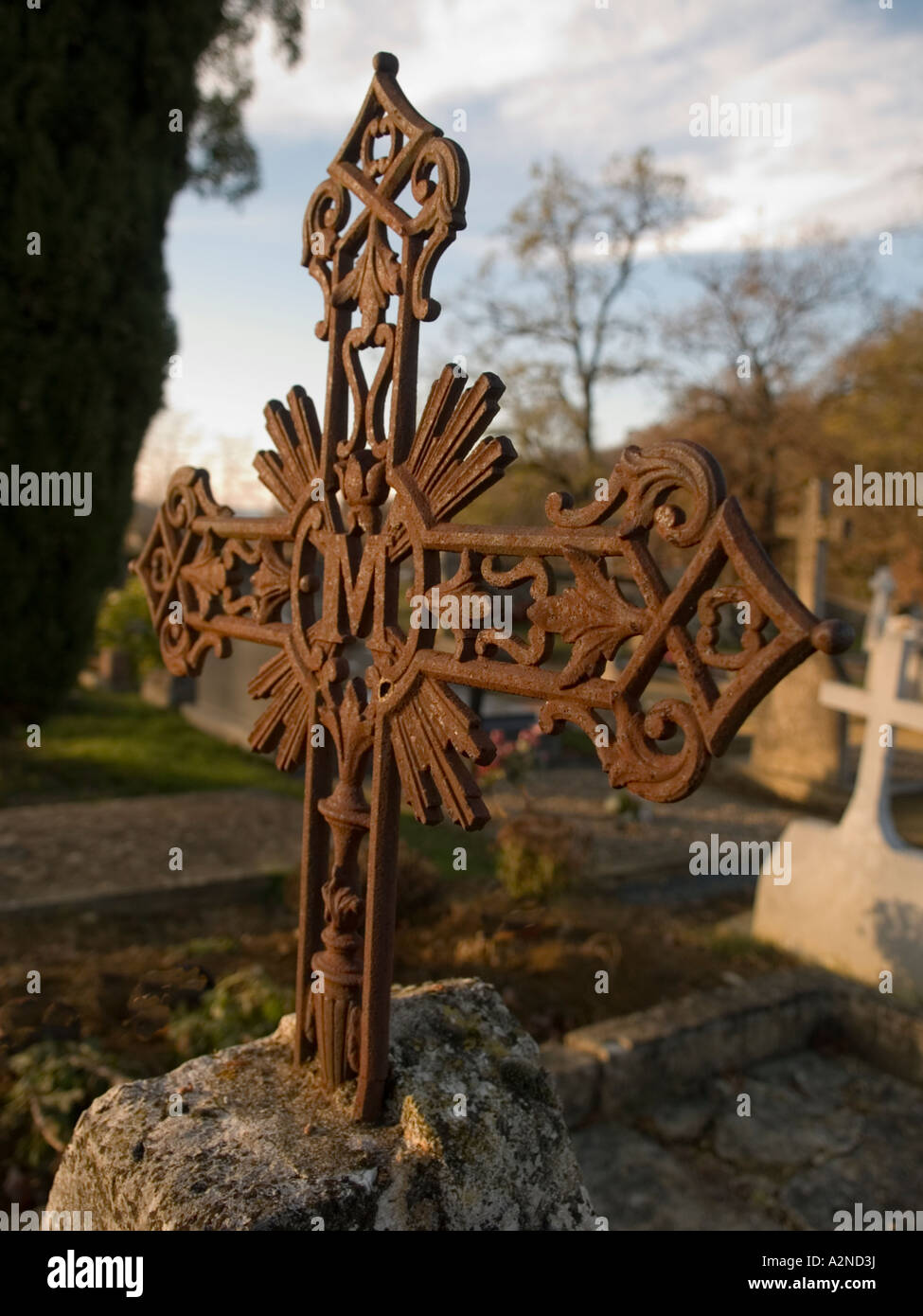 a rusty cast-iron grave cross in a French country churchyard at ...