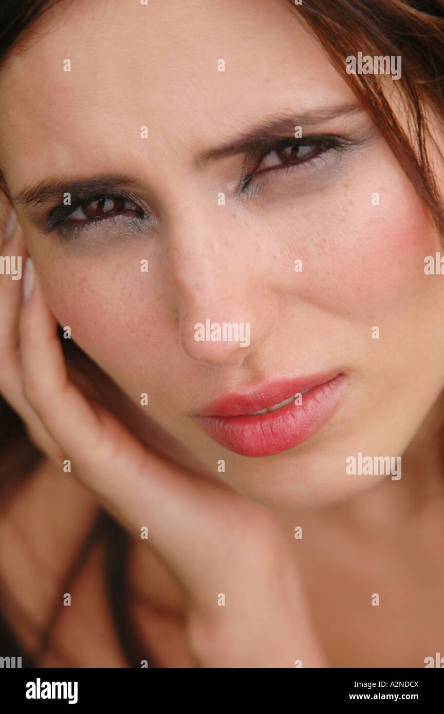 Portrait of young woman looking sad Stock Photo - Alamy