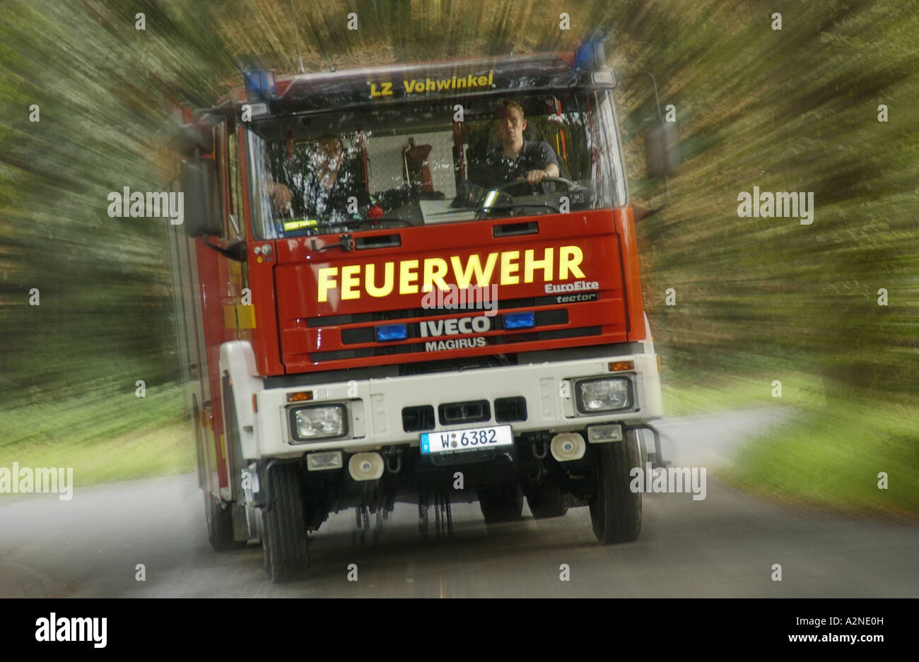 Fire engine in motion on country road Stock Photo - Alamy