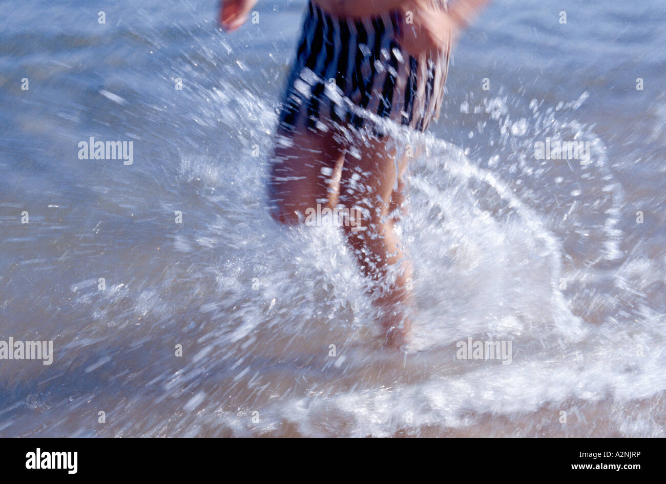 Low section view of man running in water on beach Stock Photo - Alamy