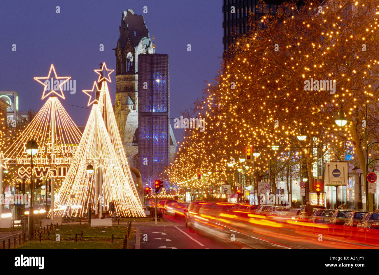 Trees lit up with Christmas lights along road at night Berlin Germany ...
