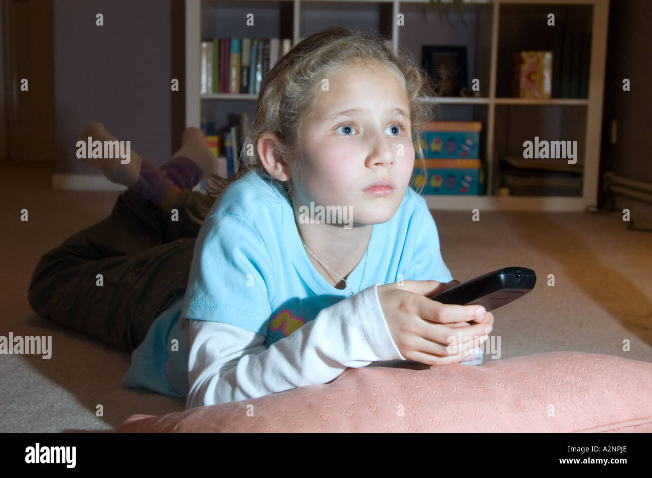 Young girl watching television at home, England, UK Stock Photo - Alamy