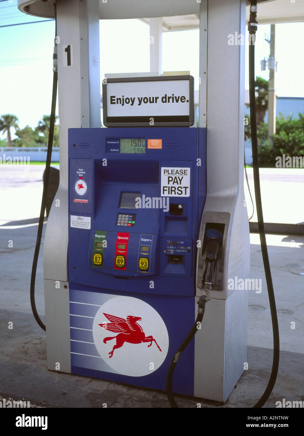 Enjoy your drive but pay before pumping, a pump on forecourt at a gas ...