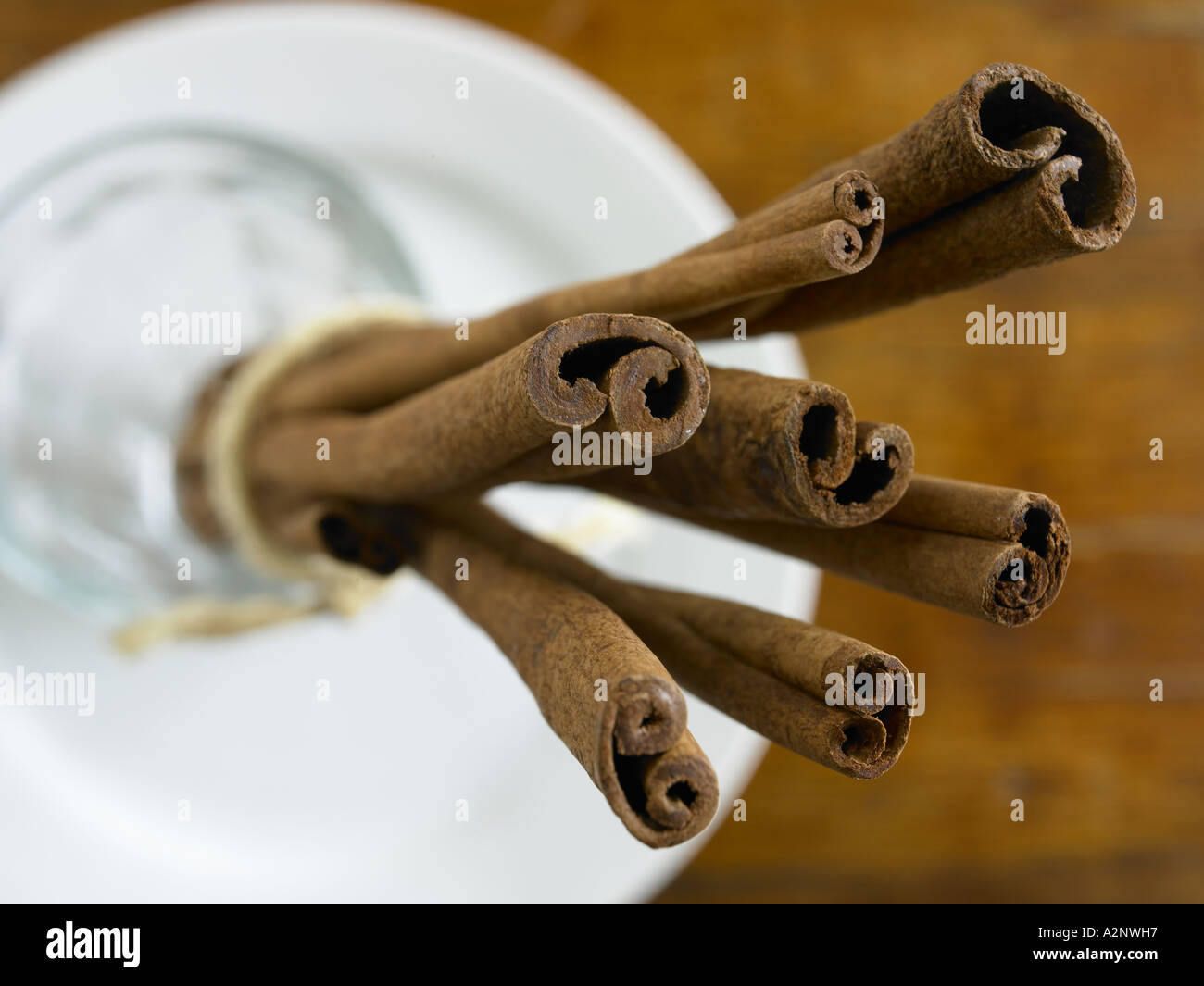 cinnamon spice sticks standing up in glass shot from above on wooden ...