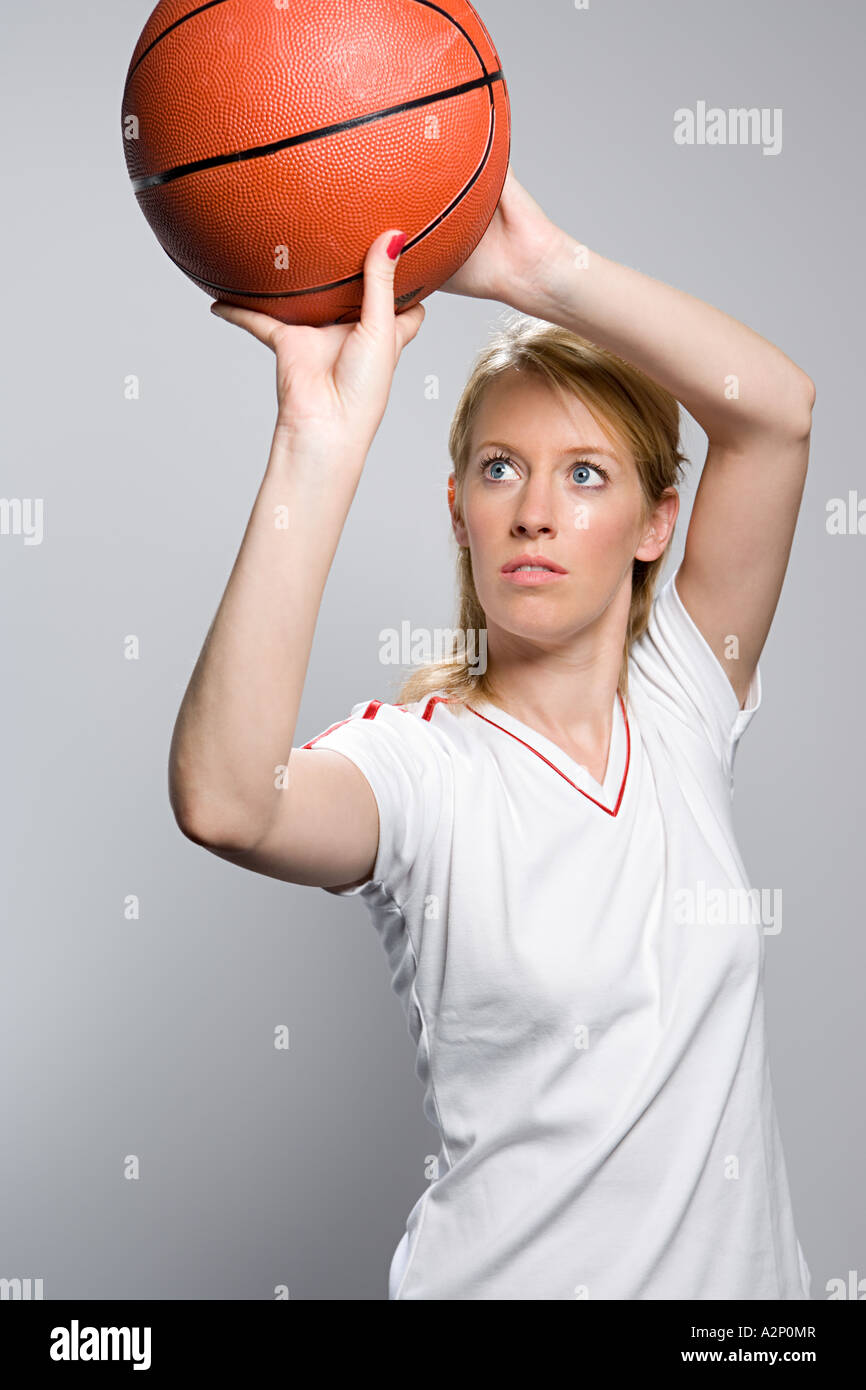 Basketball player throwing basketball Stock Photo - Alamy