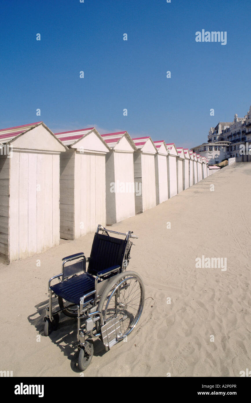 Wheelchair by row of beach huts Stock Photo - Alamy