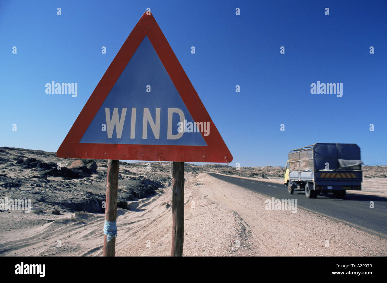 Wind sign and truck on road Stock Photo - Alamy