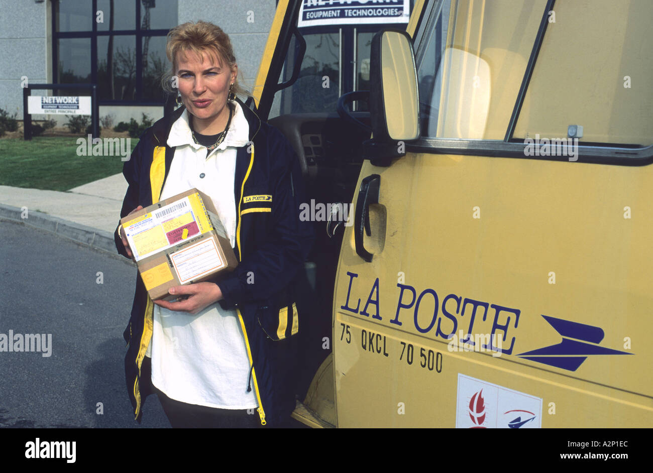 Female postal worker in France Stock Photo - Alamy