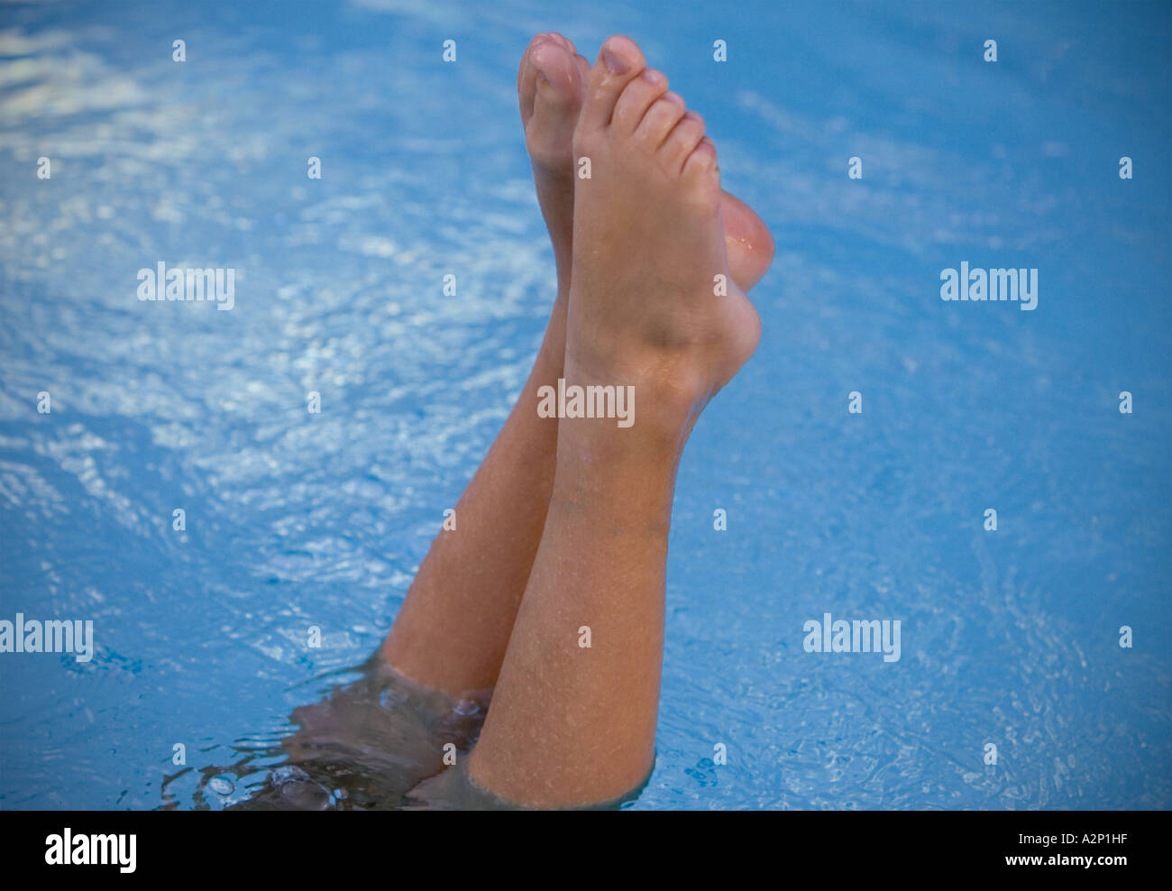 Feet sticking up in a swimming pool Stock Photo - Alamy
