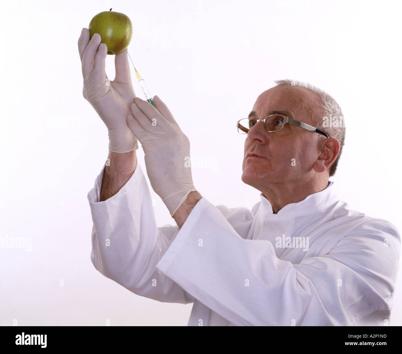 Doctor injecting an apple Stock Photo - Alamy