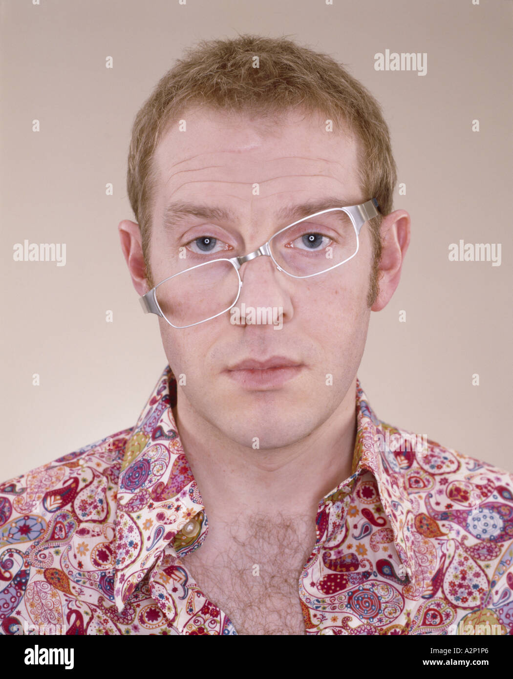 Man with glasses at a slant looking annoyed Stock Photo - Alamy