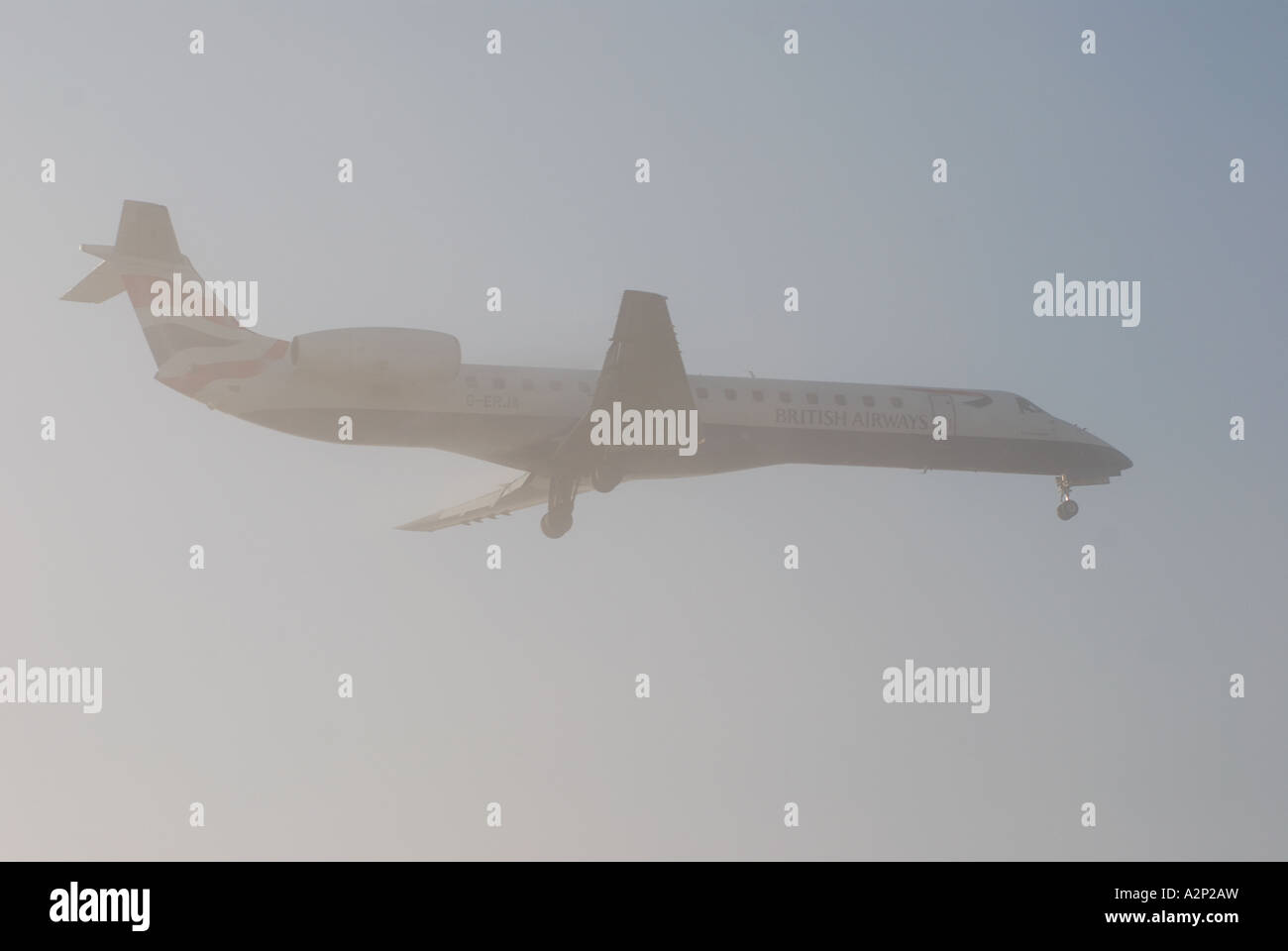 British Airways Embraer RJ145 aircraft landing in winter fog at ...