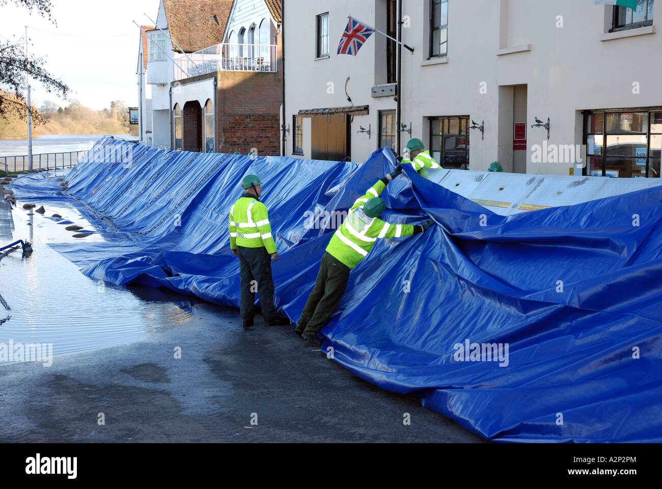 Men erecting flood defences alongside River Severn, Upton upon Severn ...