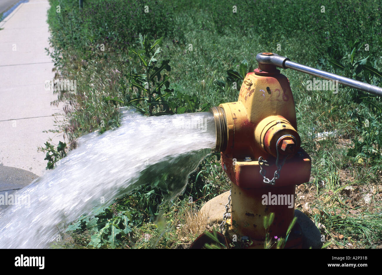 A fire hydrant being flushed Stock Photo - Alamy