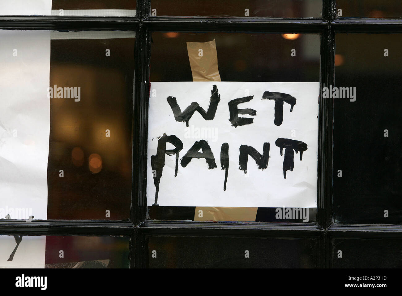 Close up wet paint sign shop window display symbol icon notice signage ...