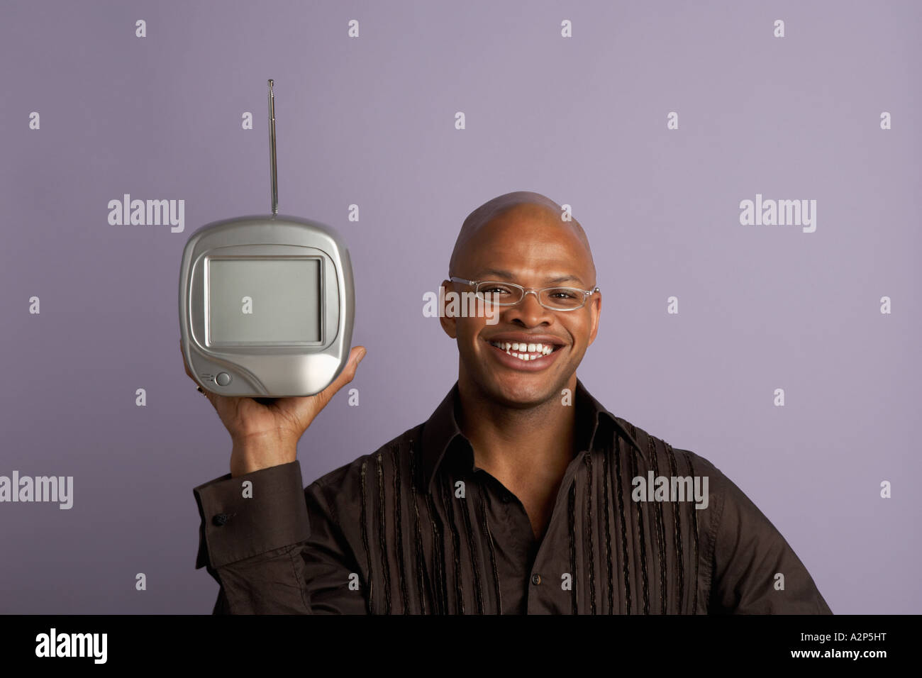 Man holding a portable television Stock Photo - Alamy