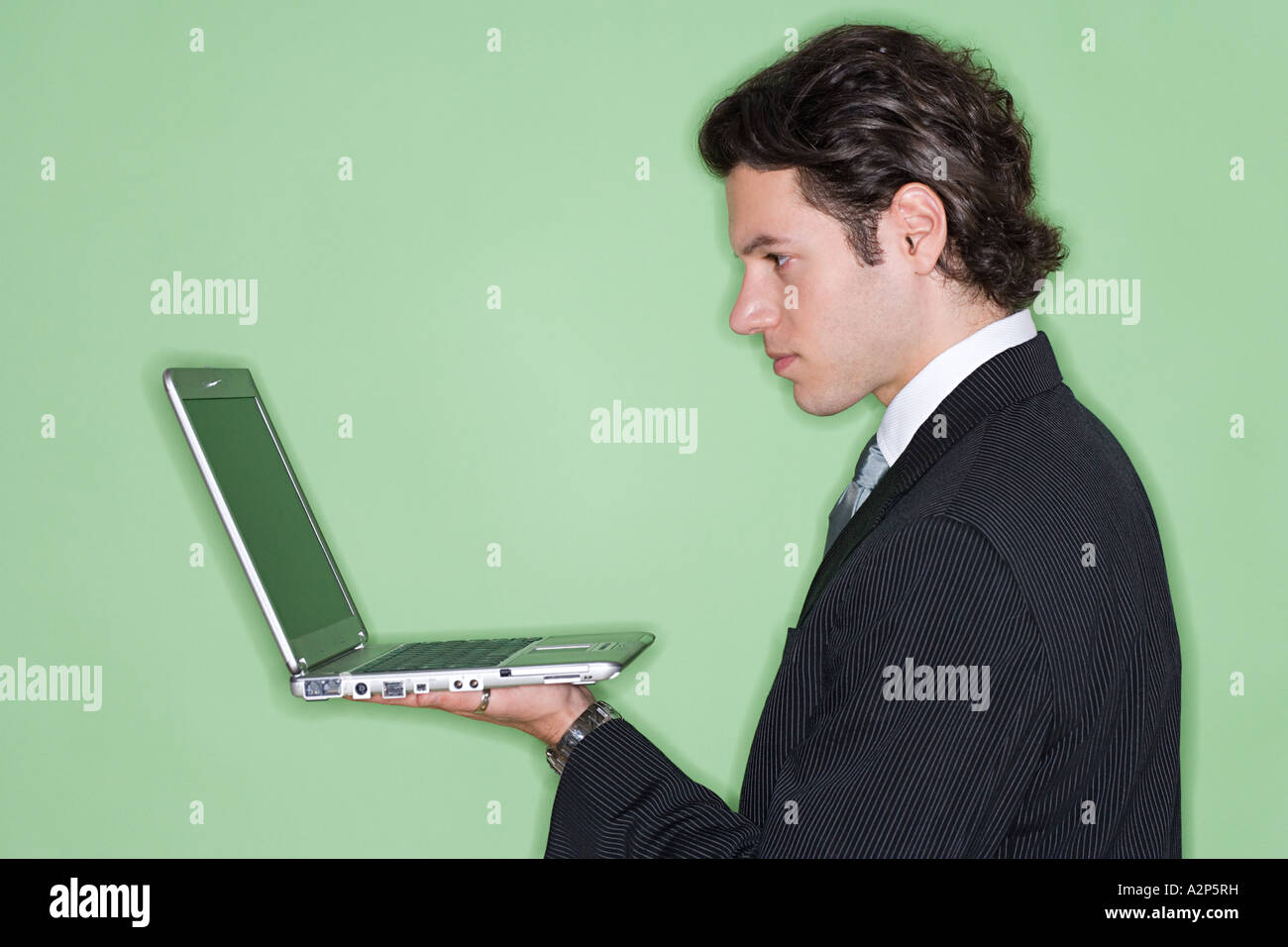 Businessman holding laptop Stock Photo - Alamy